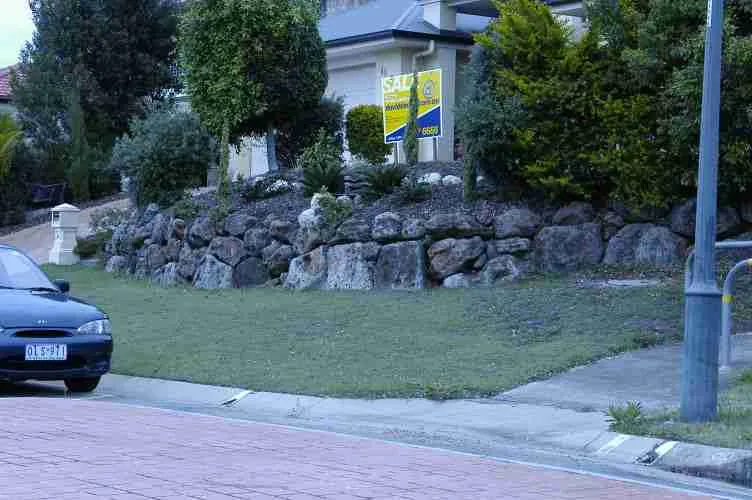 Expertly Crafted Boulder Walls: Transforming Sloping Land into ...